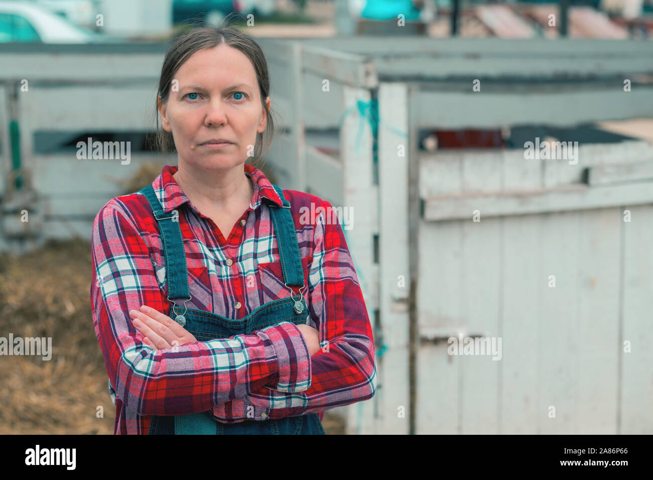 Serious female farmer posing on farm. Confident woman farm worker ...