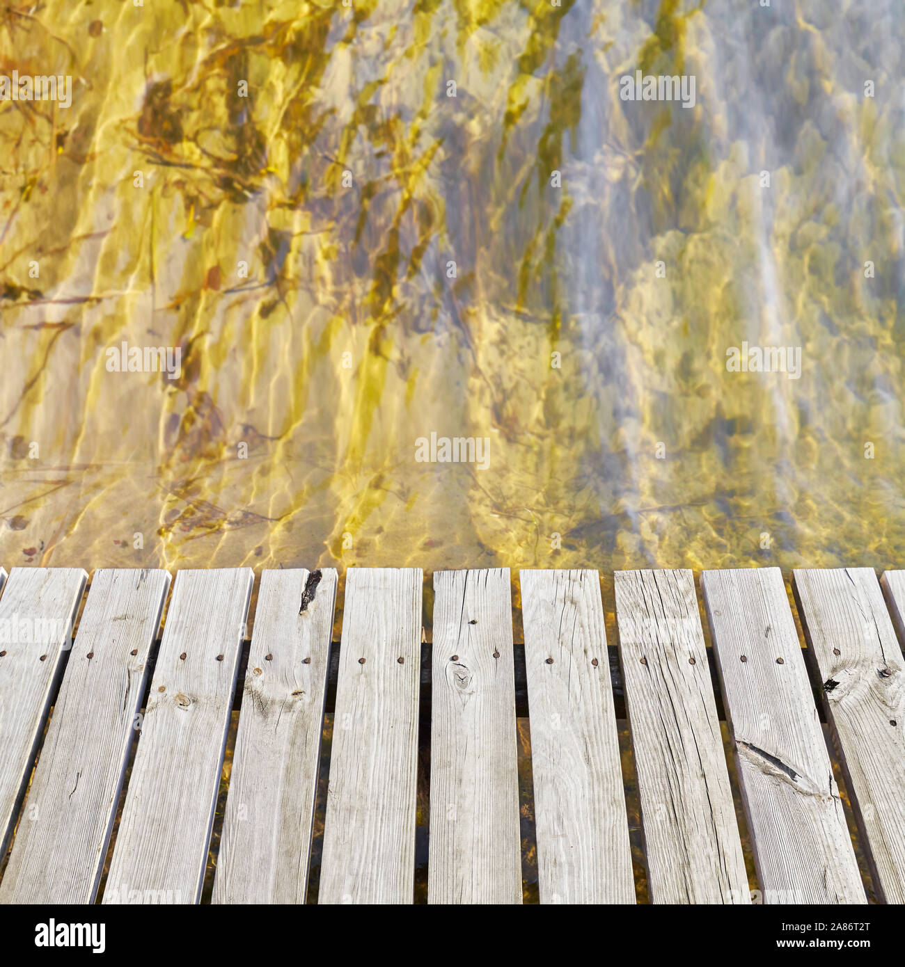 Wooden bridge boards by a water Stock Photo - Alamy