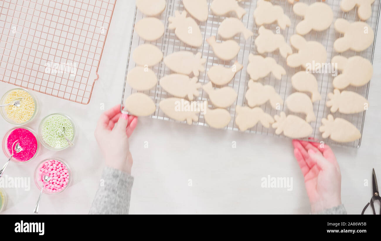 Step by step. Flat lay. Decorating Easter sugar cookies with rotal ...