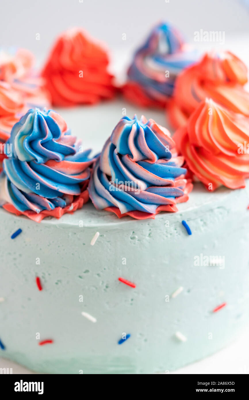 Red, white, and blue round vanilla cake with buttercream frosting for ...