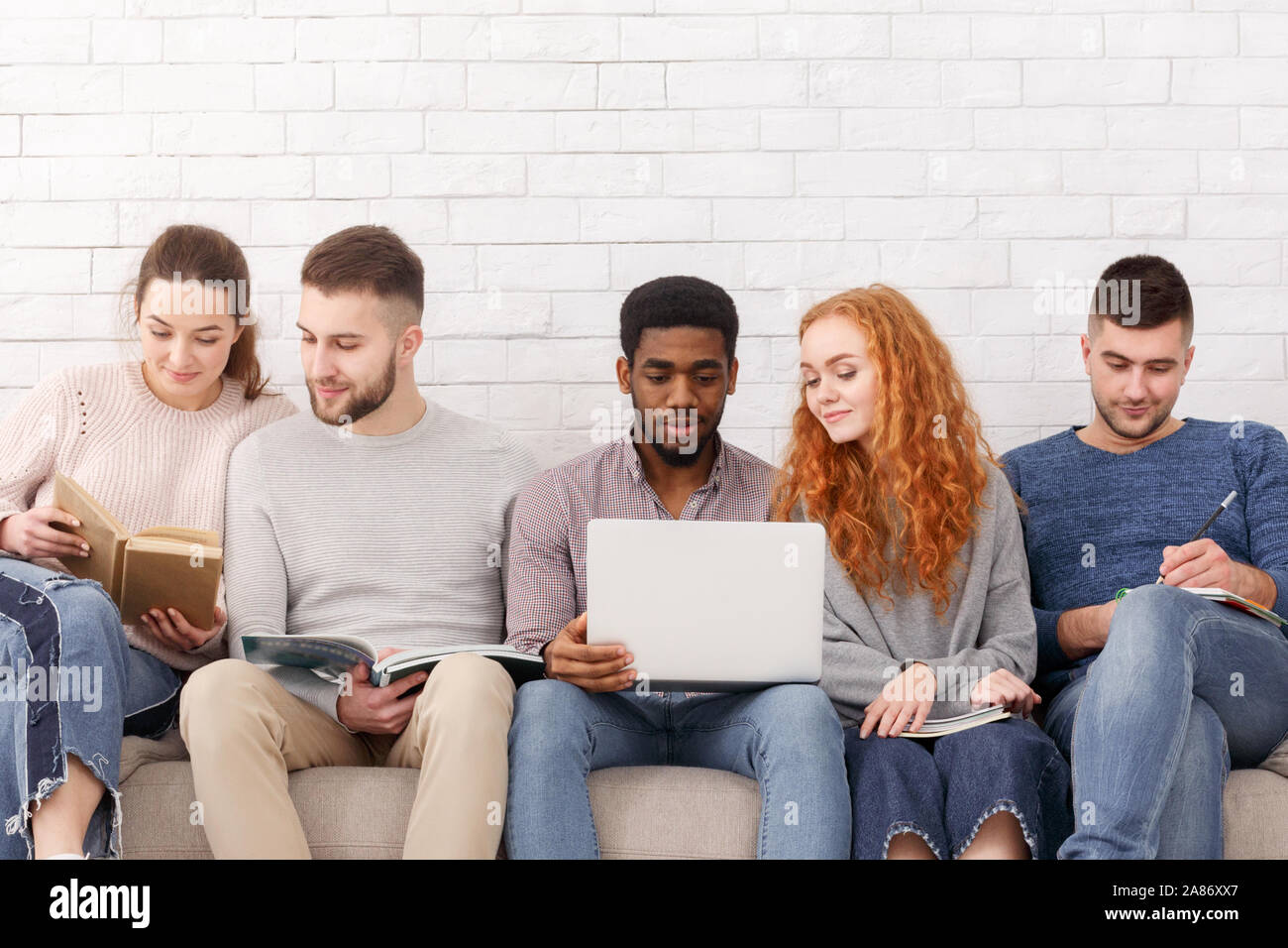 Modern education. Students with laptop and notepads Stock Photo - Alamy