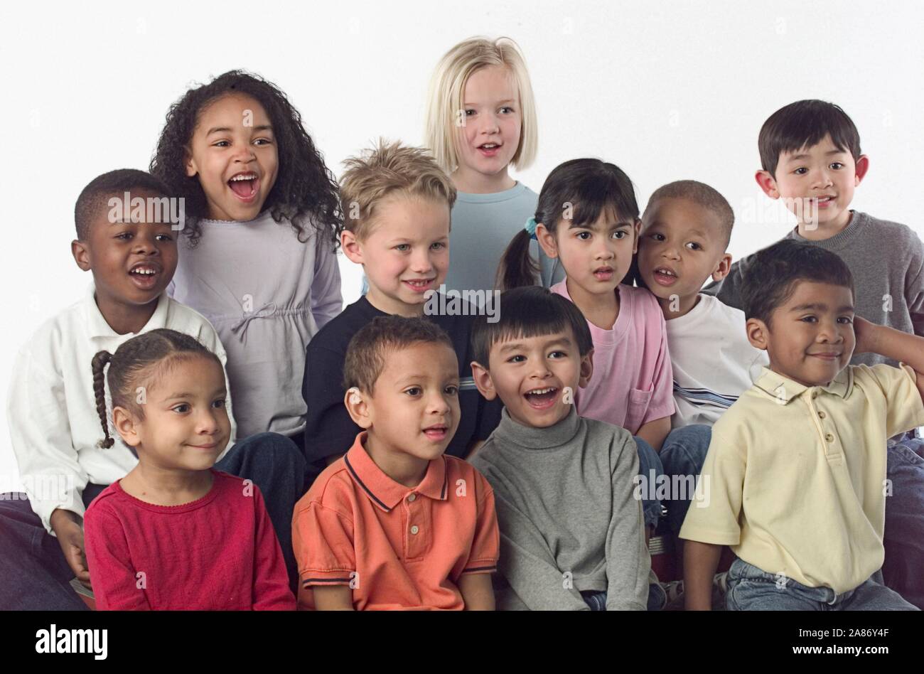 A large group of multi ethnic children photographed on a white ...