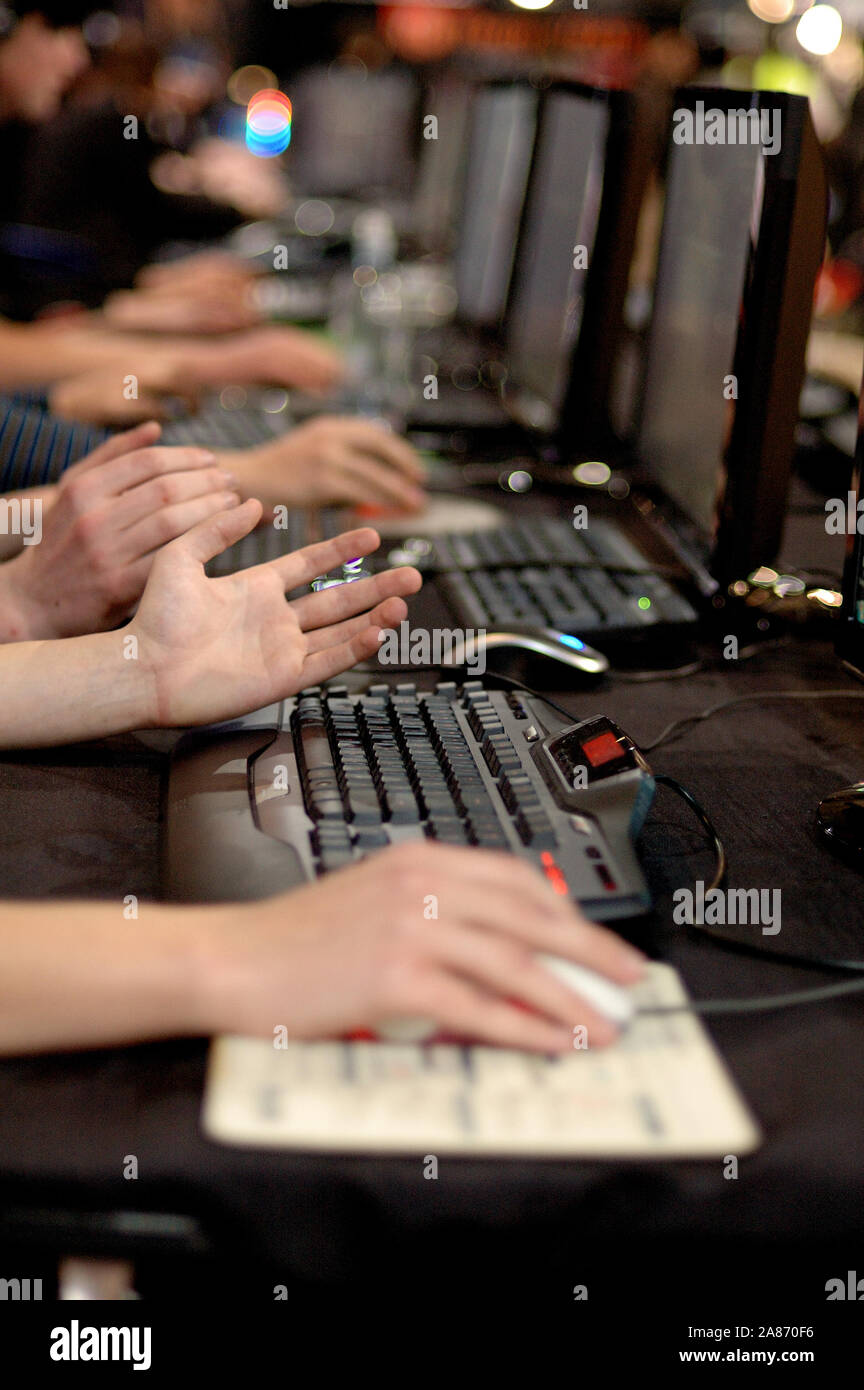 gamers competing in cyber games using computers, gaming consoles and ...