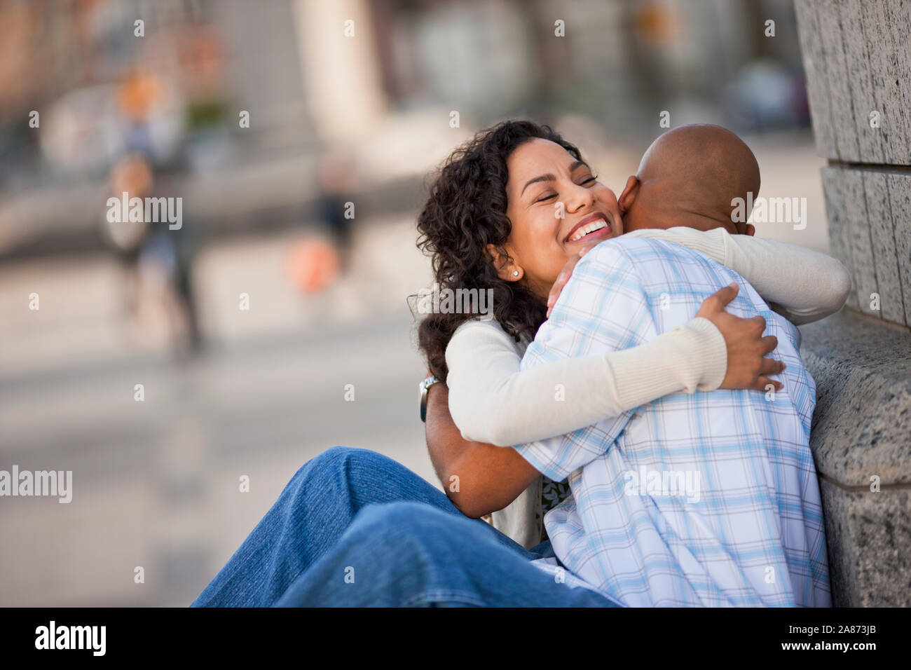 Happy young woman hugging her partner Stock Photo - Alamy