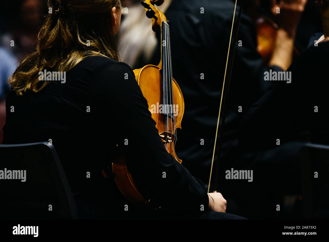 Woman fiddler during a concert, background in black Stock Photo - Alamy