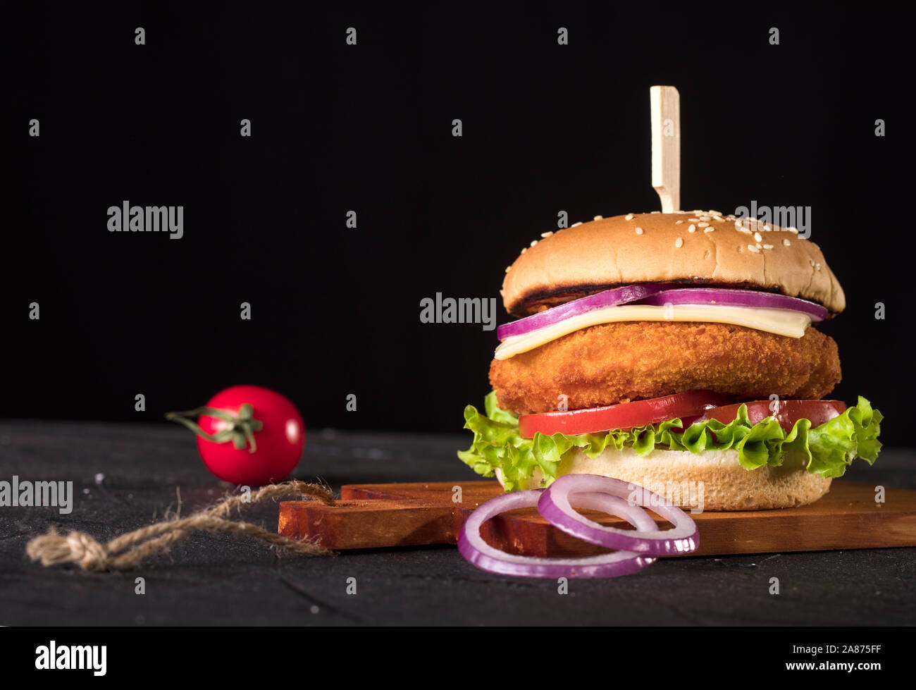 Fresh delicious burger with meatball, cheese, tomato, onion and lettuce ...
