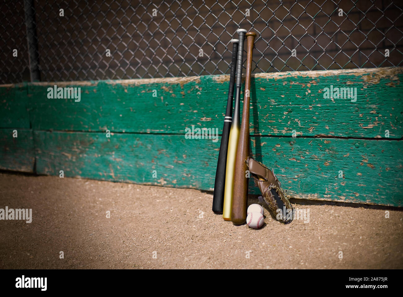 Leather baseball mitt next to baseball bats and balls Stock Photo - Alamy