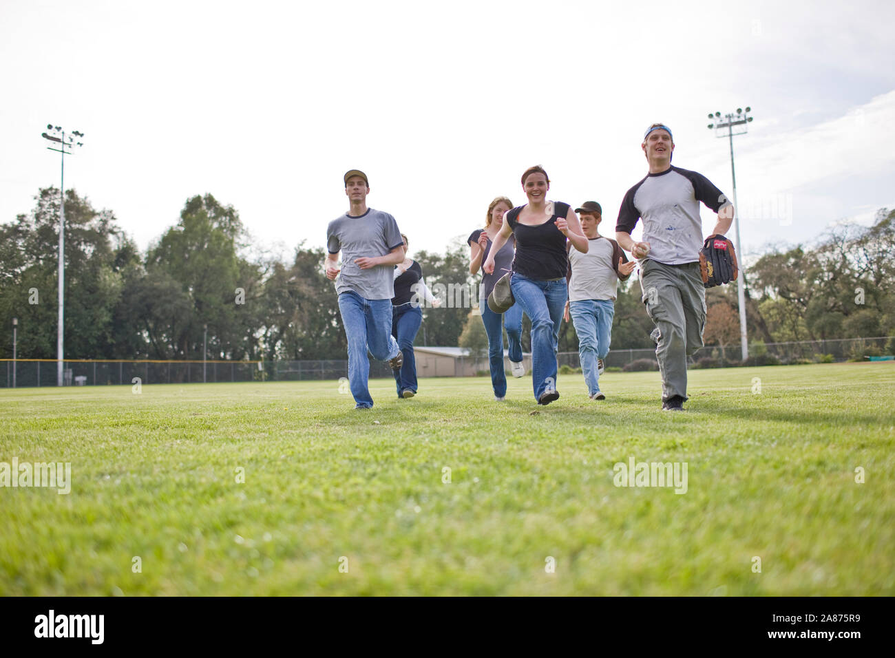 Young man running across field hi-res stock photography and images - Alamy