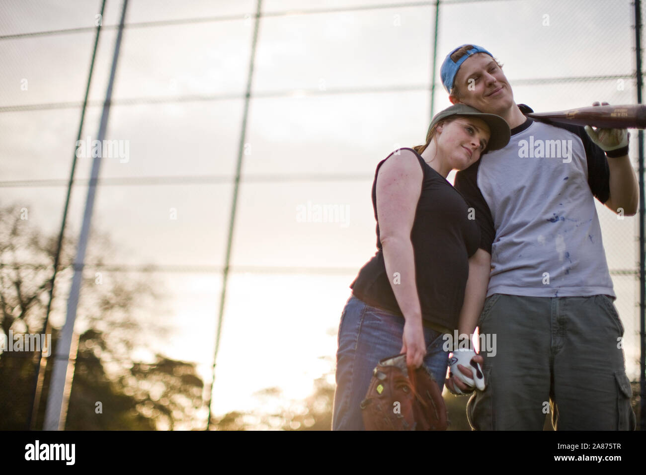 Couple standing on sport field holding hands Stock Photo - Alamy