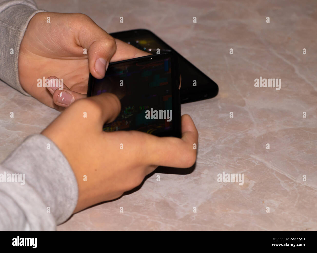 Boys playing mobile phone games hi-res stock photography and images - Alamy