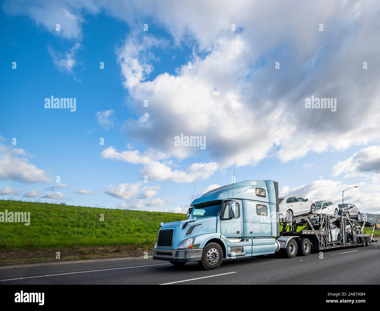 Big rig light blue long haulage car hauler semi truck with drivers rest ...