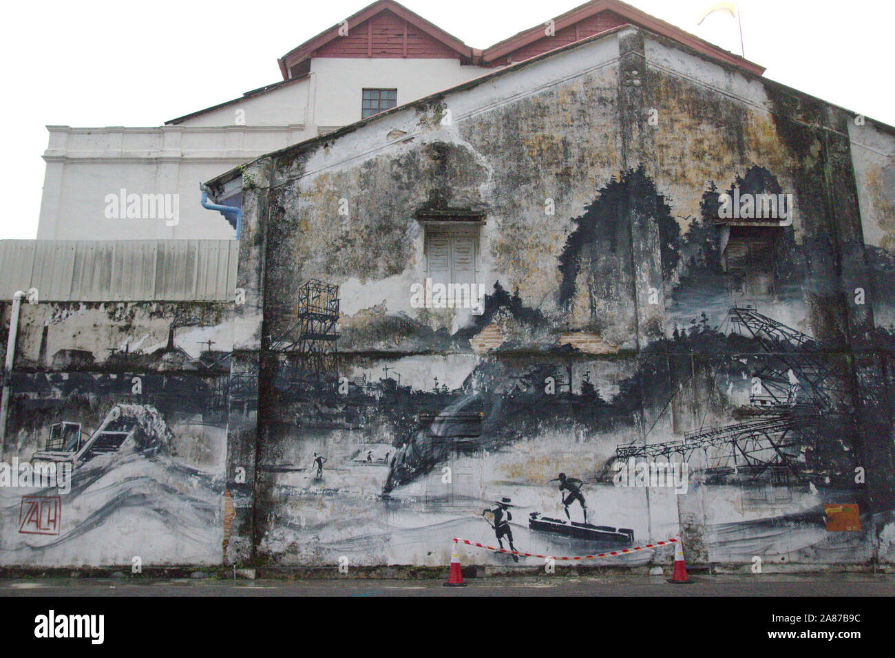 A massive mural depicts the old tin mining days on a wall in the Old ...
