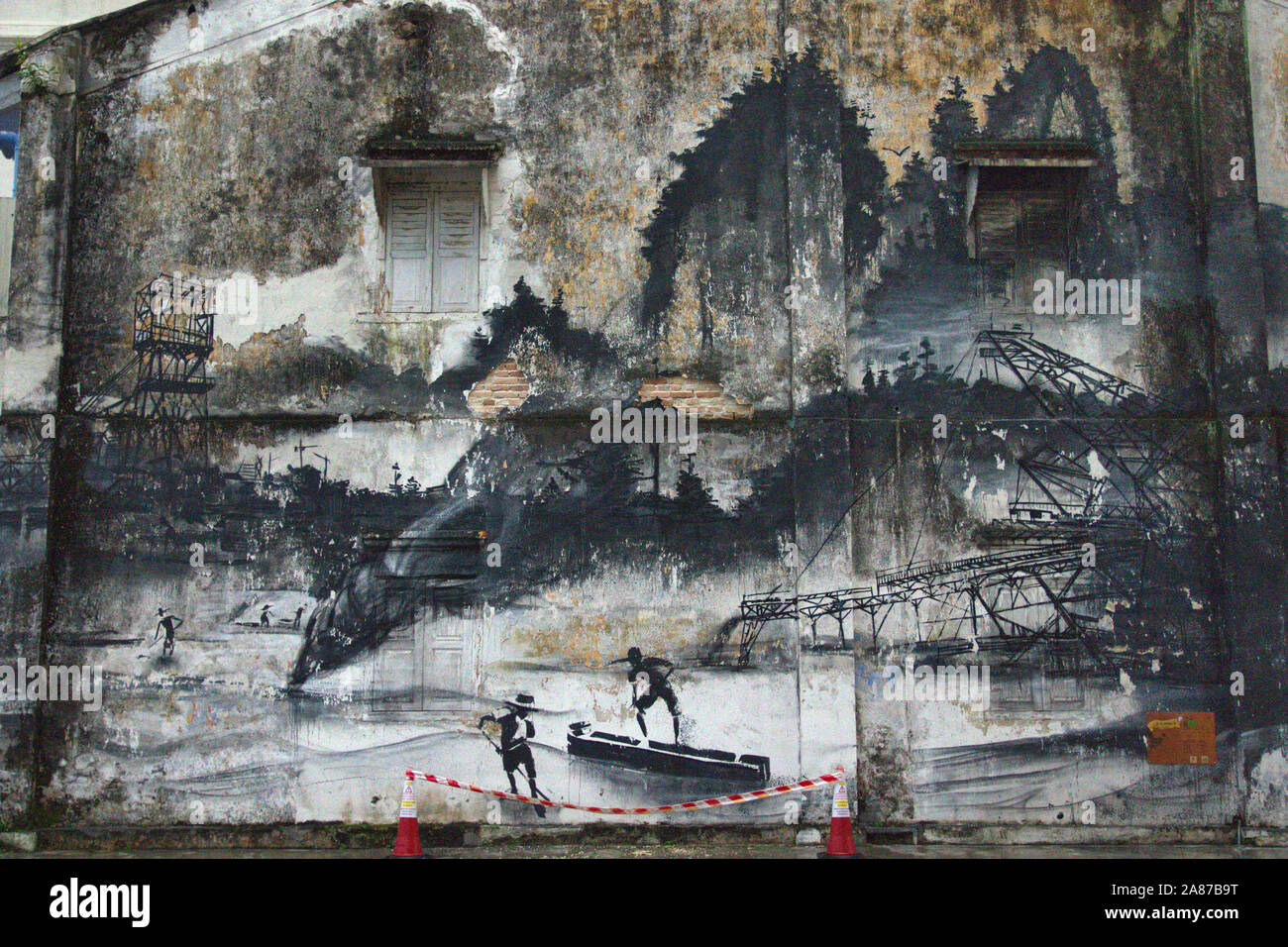 A massive mural depicts the old tin mining days on a wall in the Old ...