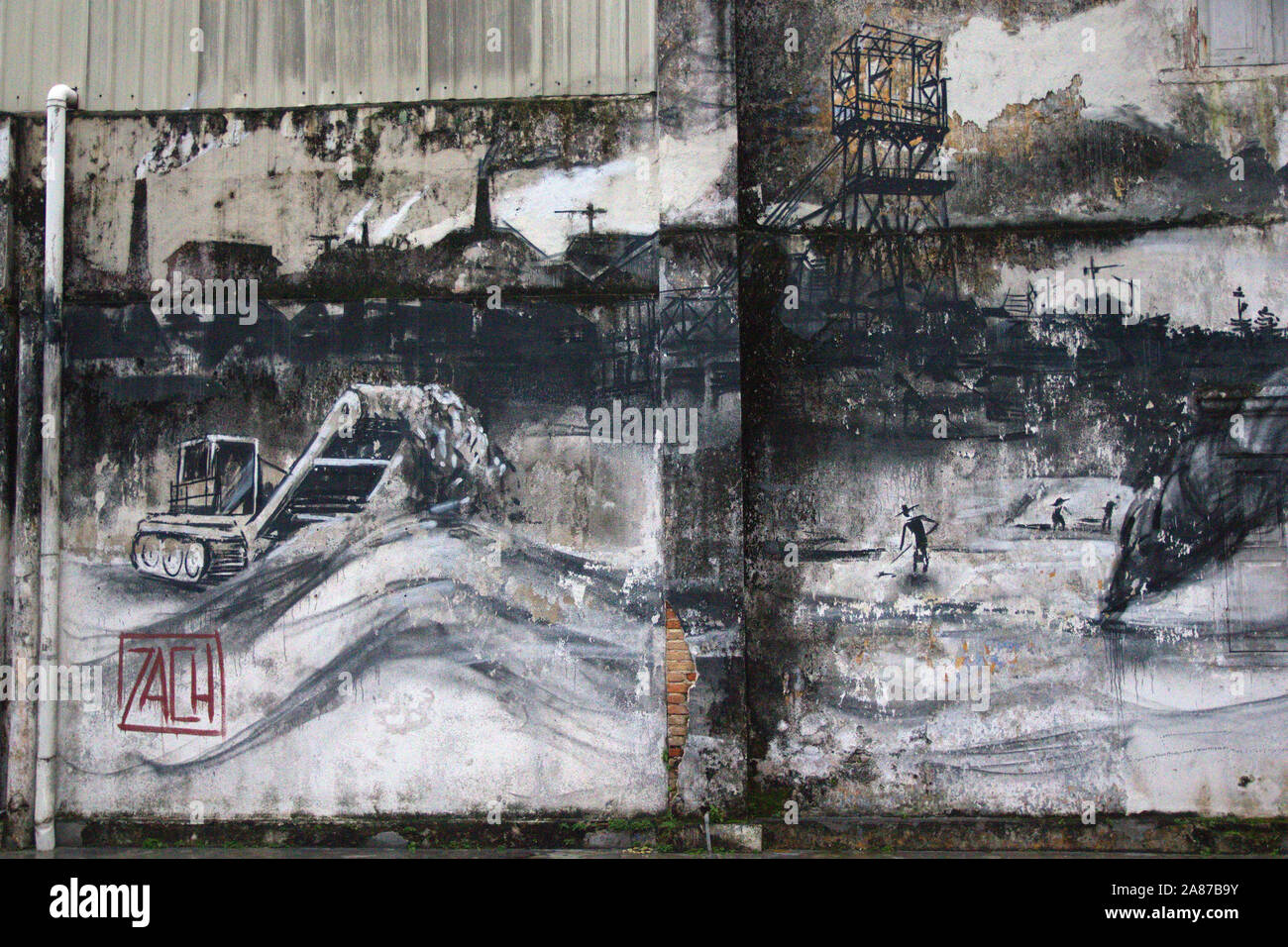 A massive mural depicts the old tin mining days on a wall in the Old ...