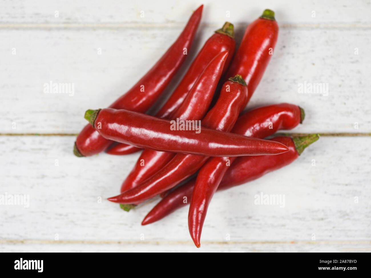Red chili pepper on a white wooden background / fresh chilli hot and ...