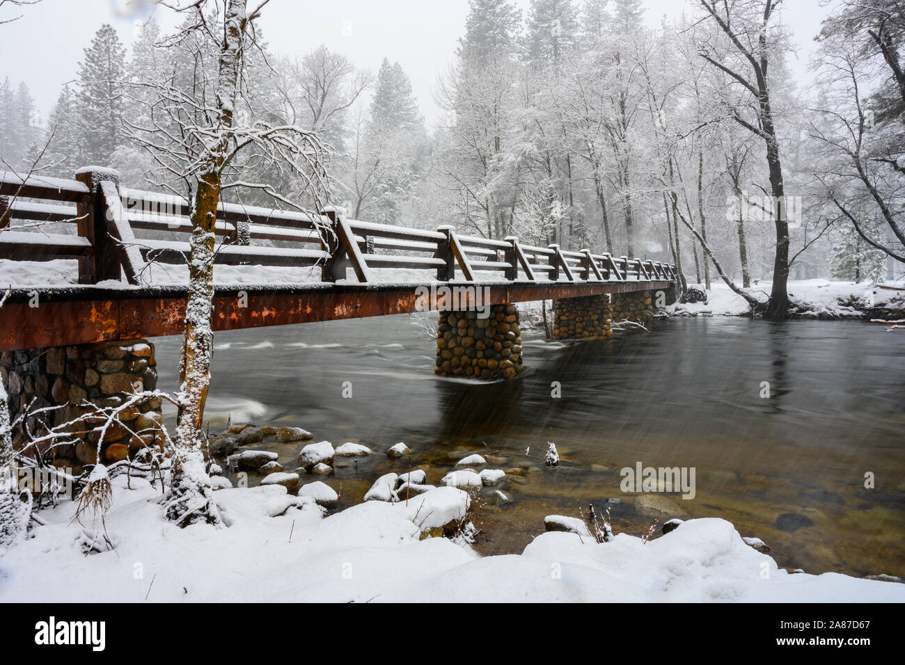 Long Exposure of Driving Snow and Bridge Over The Merced River Stock ...