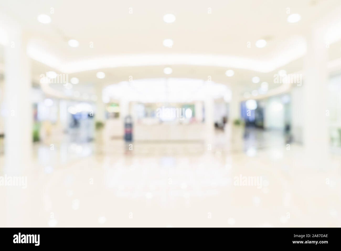 Abstract Blur white modern hall interior with bright light bokeh ...