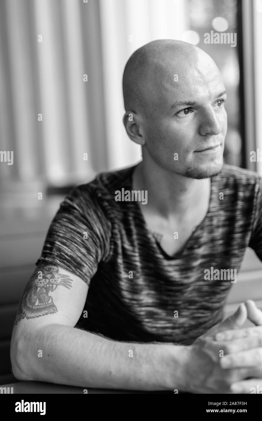 Bald man sitting restaurant table Black and White Stock Photos & Images ...