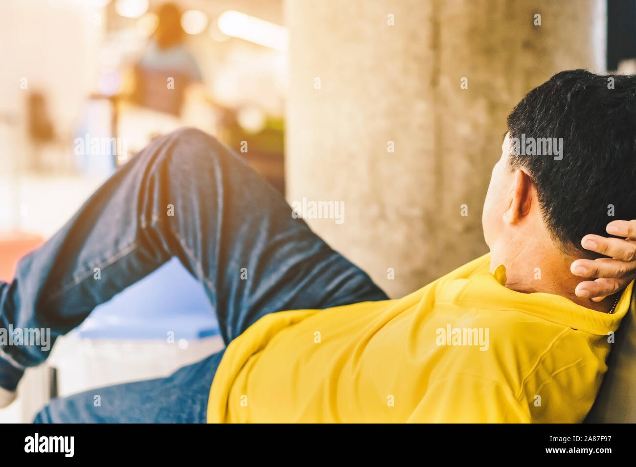 Tired passenger napping on a benches while waiting for boarding in the ...