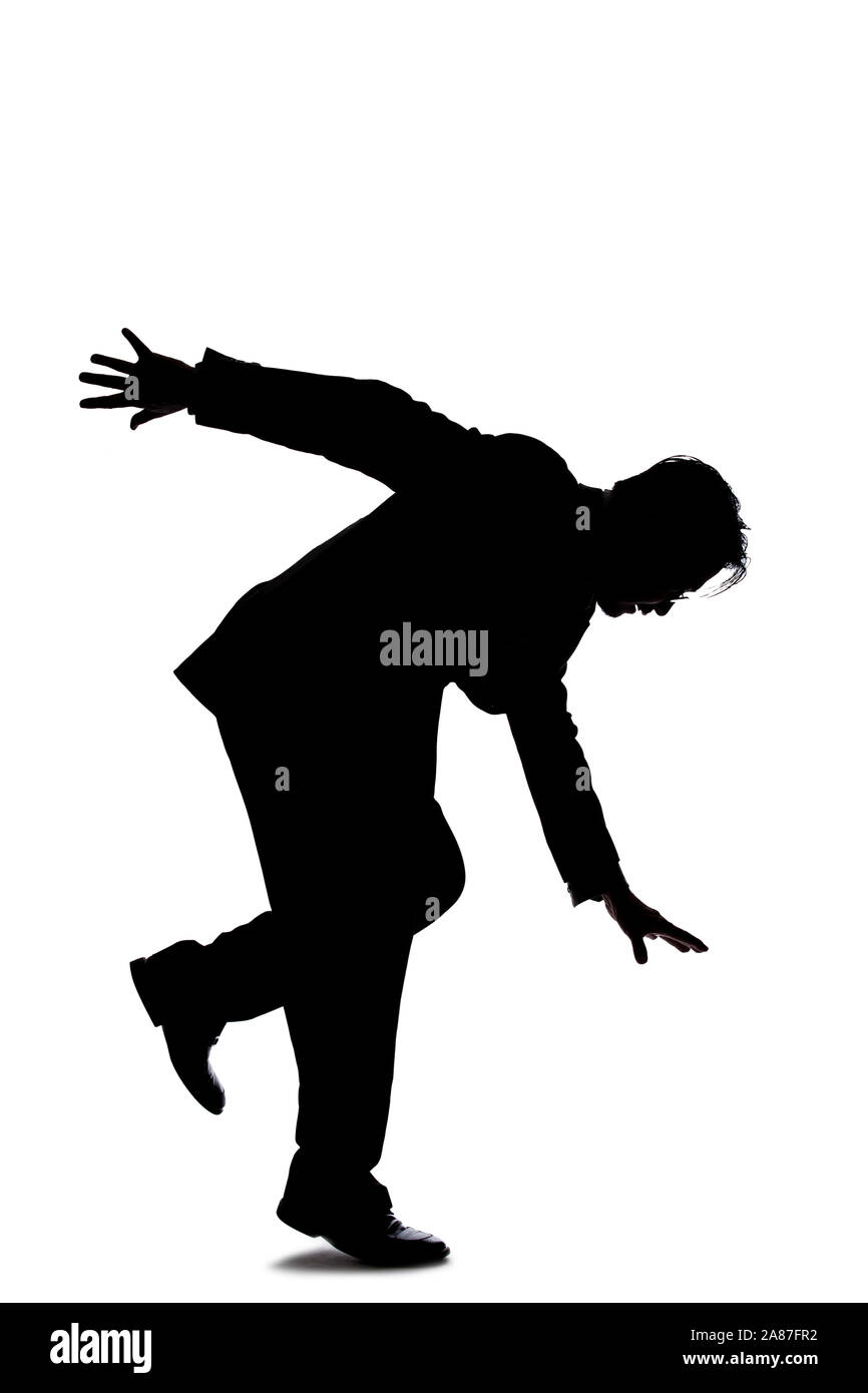 Silhouette of a backlit model posing as a businessman on a white ...