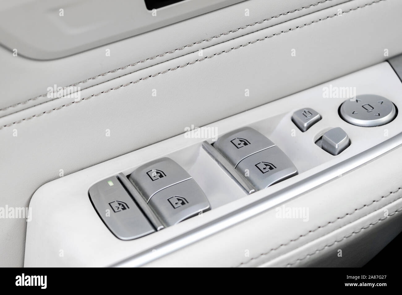 Door handle with power window control buttons of a luxury passenger car ...