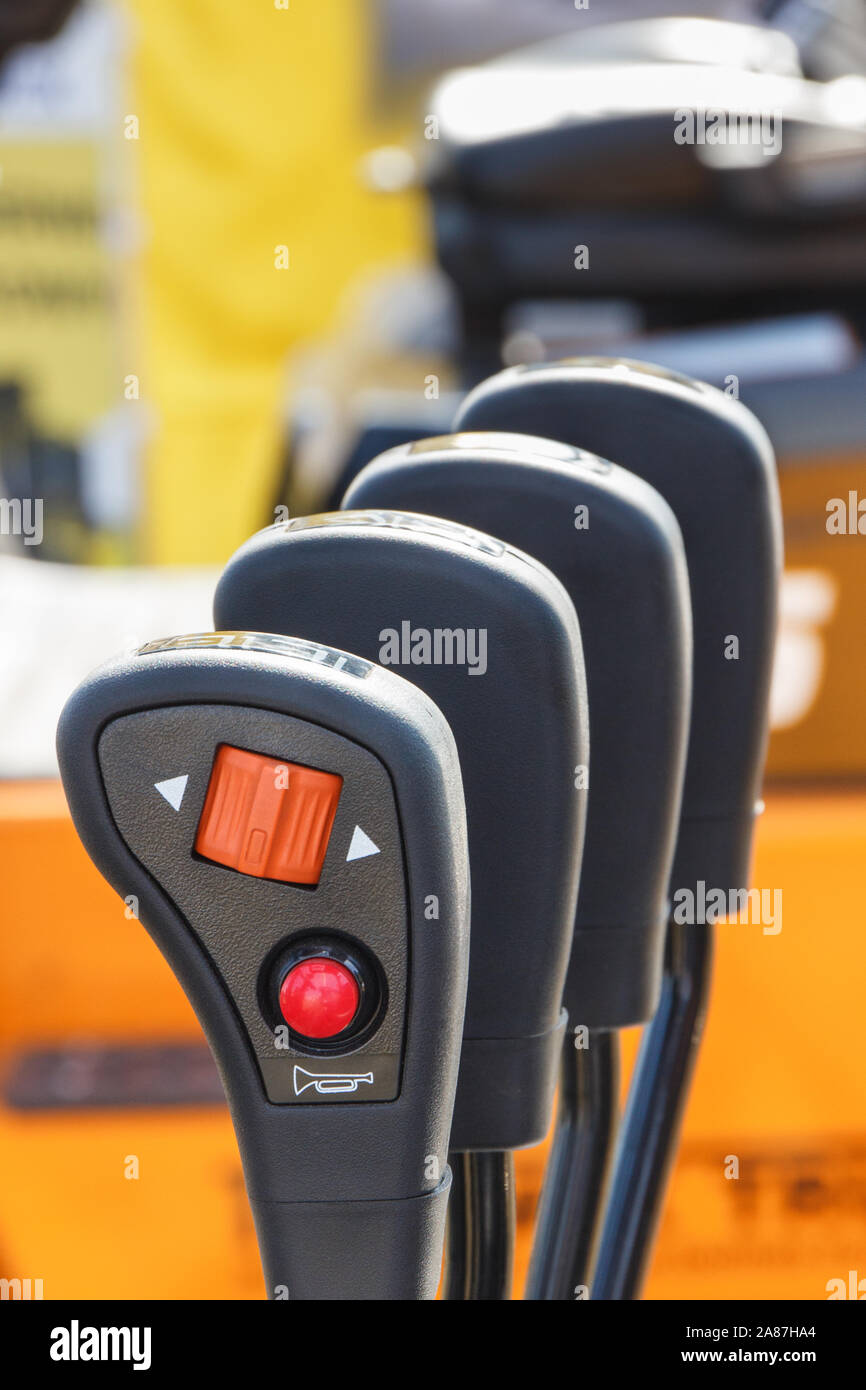 Operating control levers with buttons in loader machine or other ...