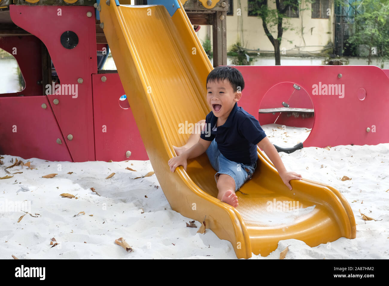Child playing on outdoor playground. Kids play on school or ...
