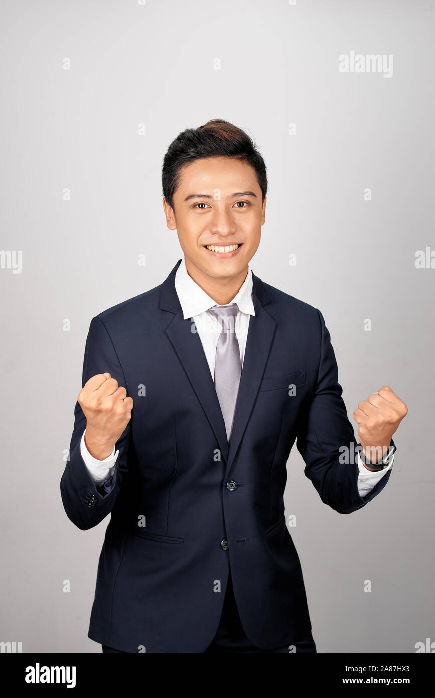 Happy businessman celebrating his success over white background ...
