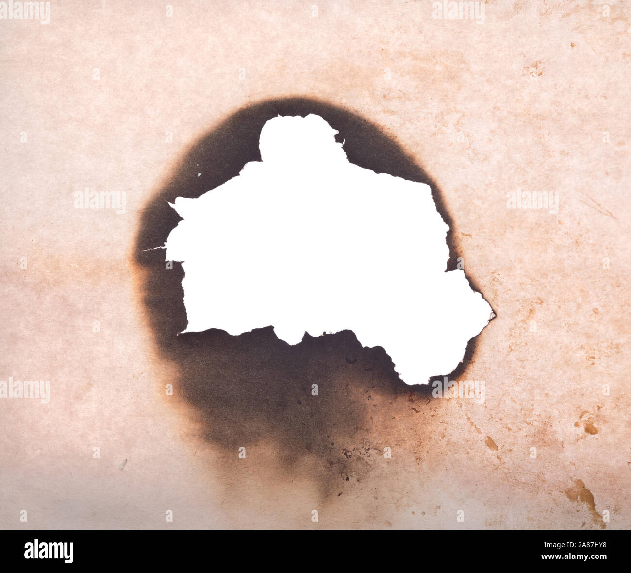 Burnt hole in a paper Stock Photo - Alamy