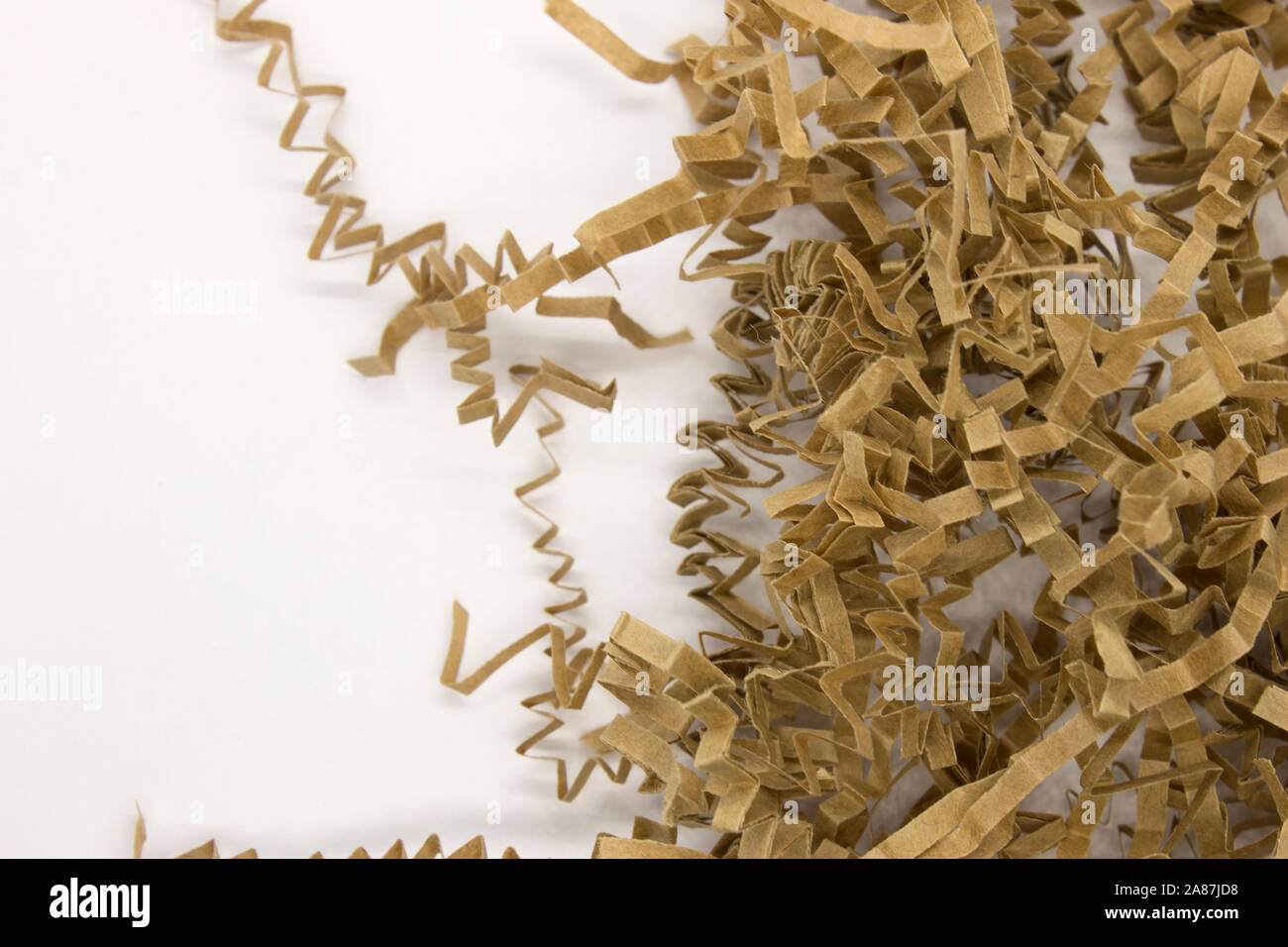 This is a photograph of Brown shredded paper isolated on a White ...