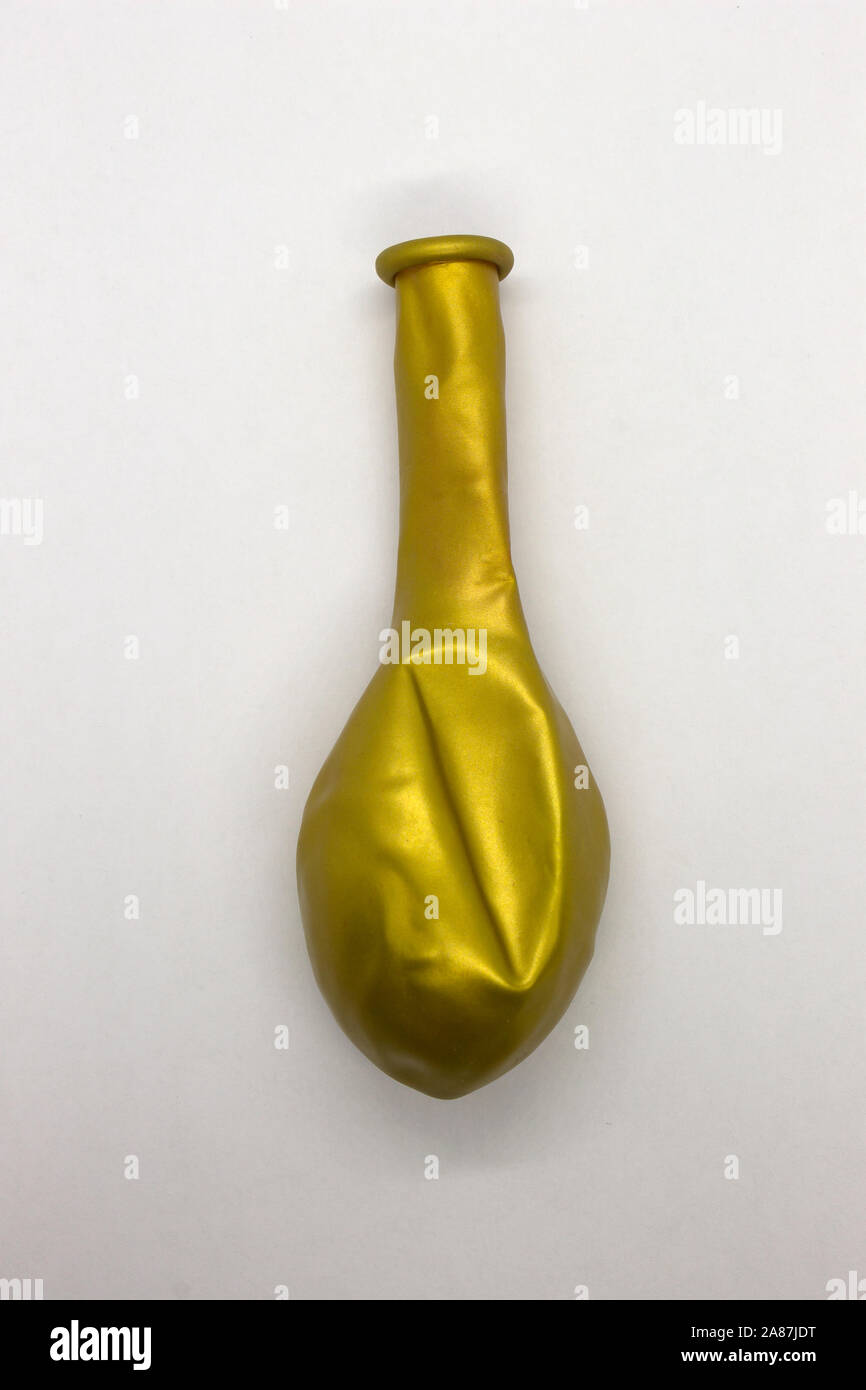 This is a photograph of a Gold Metallic Balloon isolated on a White ...