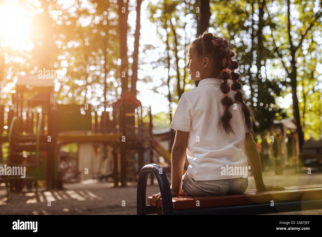 girl sitting on a bench Stock Photo - Alamy