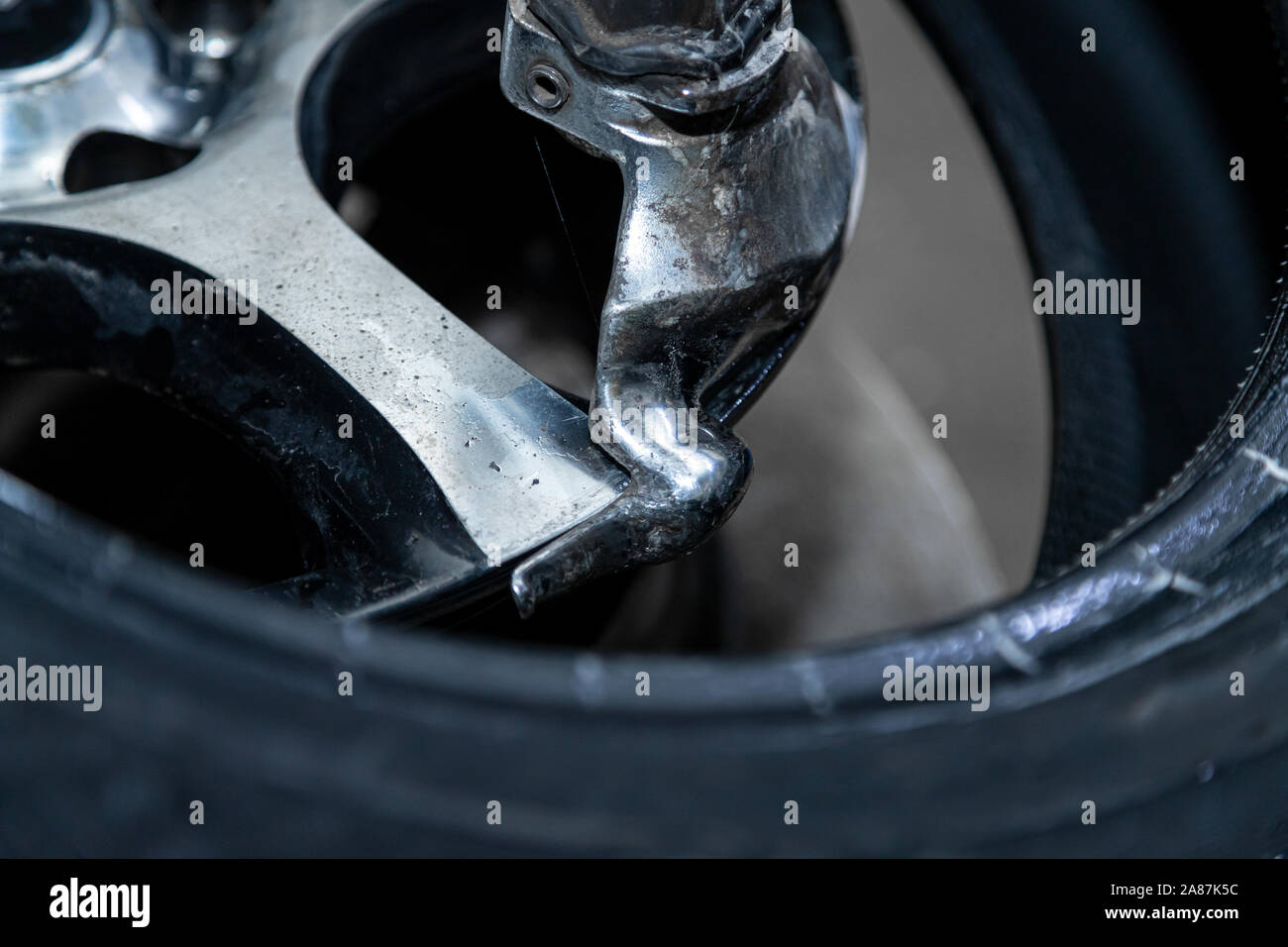 A close-up of tire fitting a car wheel: separating old tires from ...