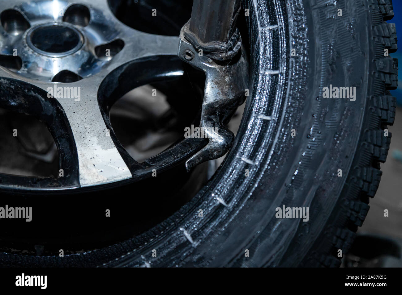 A close-up of tire fitting a car wheel: separating old tires from ...