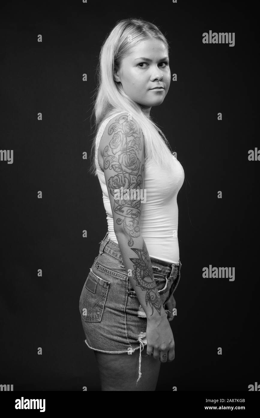 Young beautiful rebellious woman against black background Stock Photo ...