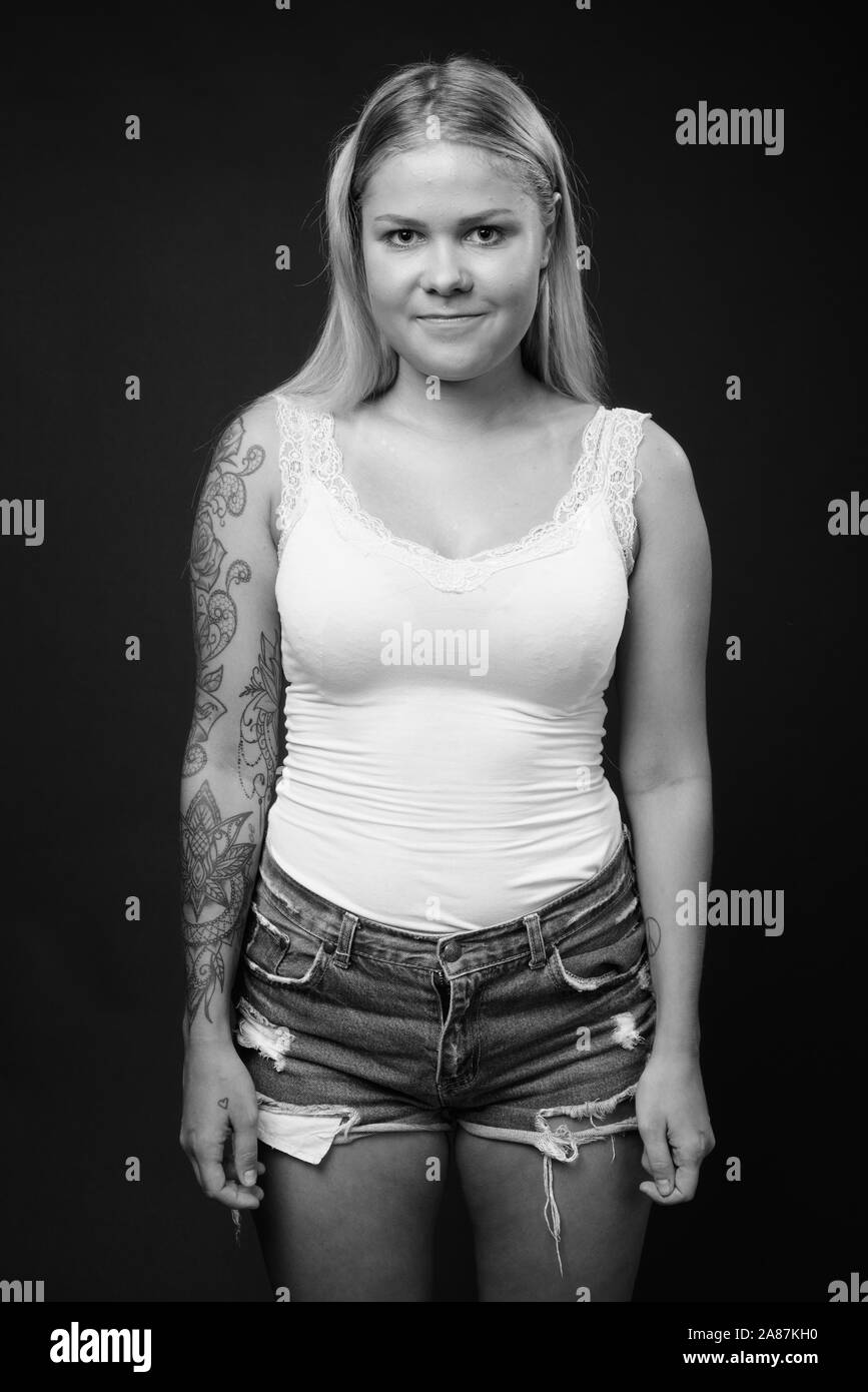 Young beautiful rebellious woman against black background Stock Photo ...