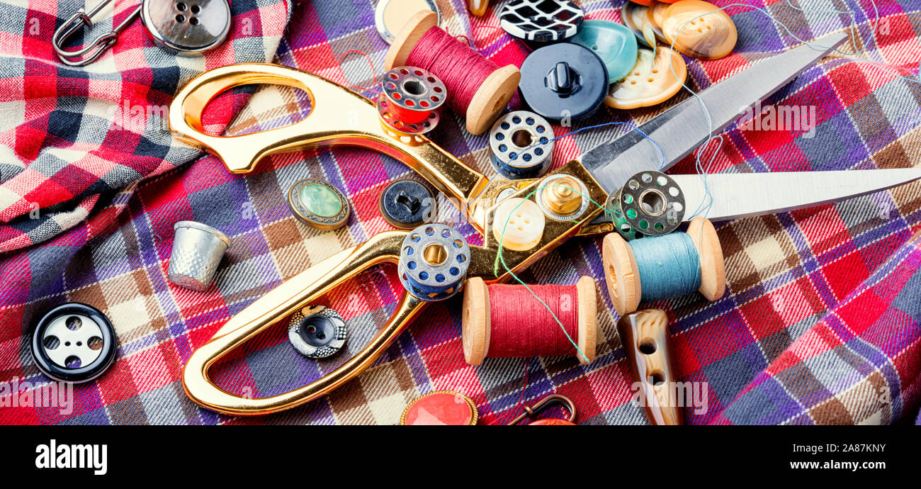 Sewing tools, scissors, buttons and threads on fabric Stock Photo - Alamy