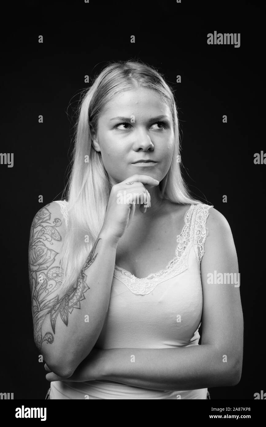 Young beautiful rebellious woman against black background Stock Photo ...