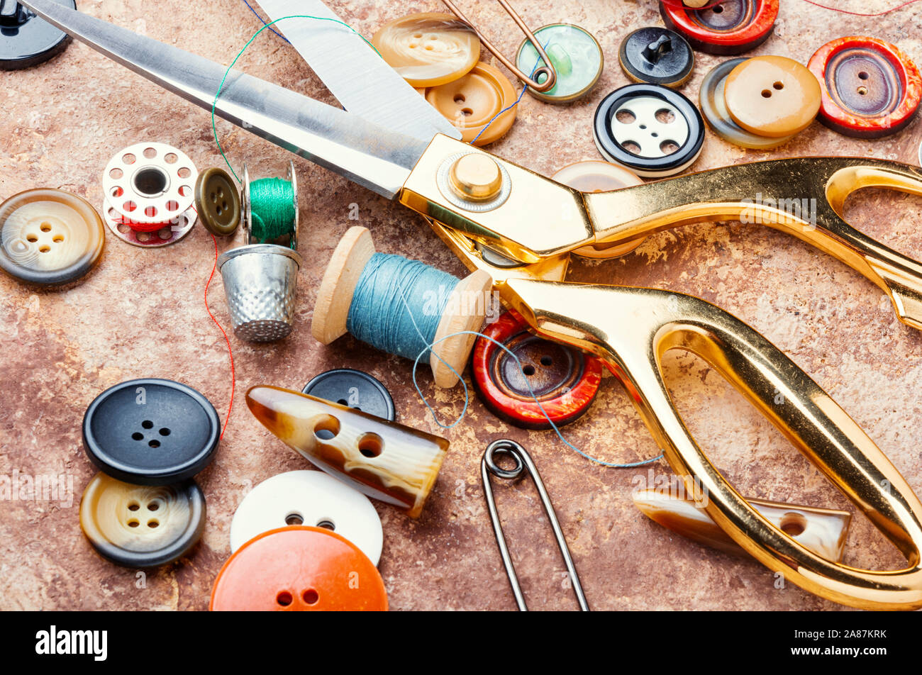 Sewing tools, scissors, many buttons and threads Stock Photo - Alamy