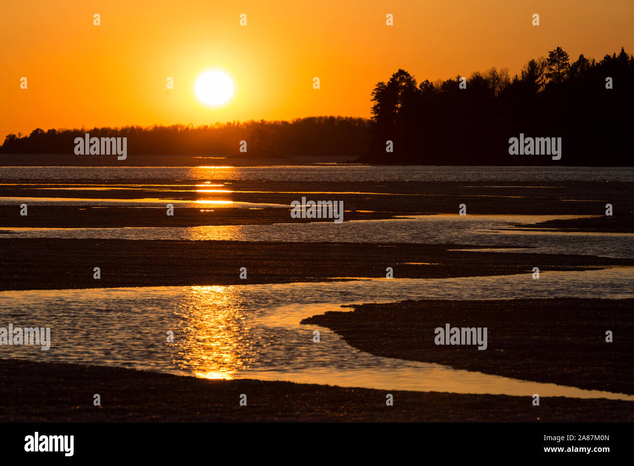 Sunset reflected off the water near Ash River Visitor Center in ...