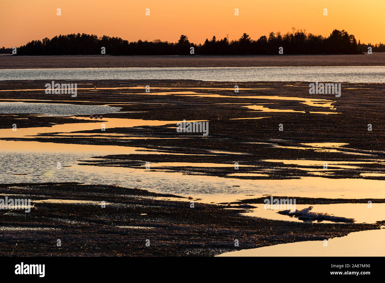 Sunset reflected off the water near Ash River Visitor Center in ...