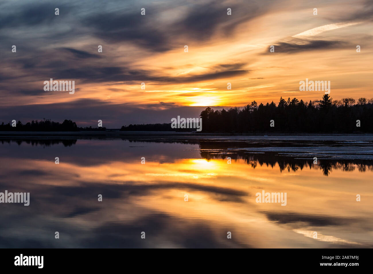 Sunset reflected off the water near Ash River Visitor Center in ...