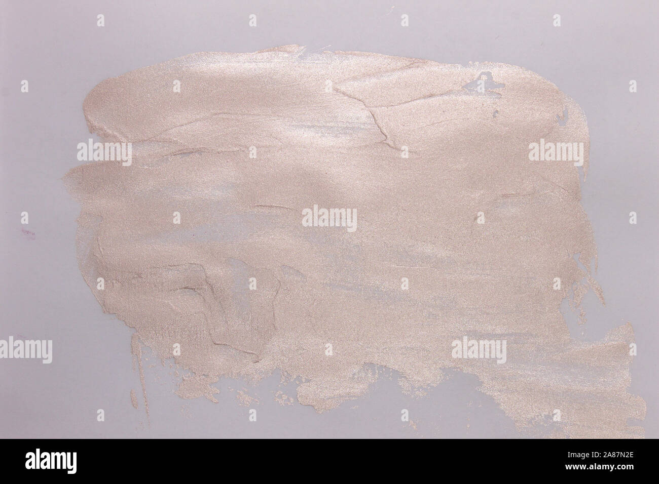 This is a photograph of a Pearly Pink liquid highlighter swatch ...