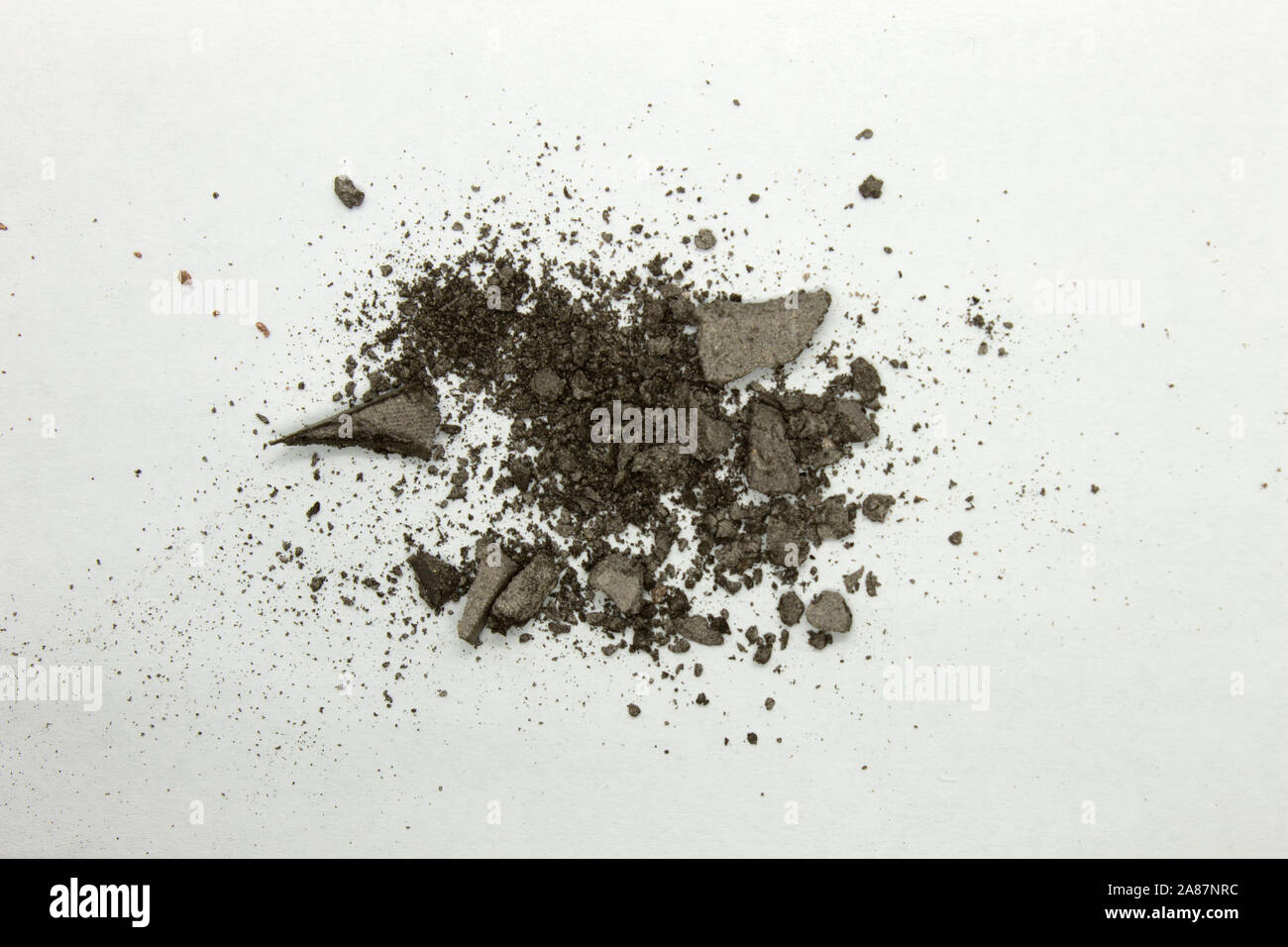 This is a photograph of a shimmery greyish Brown powder Eye shadow ...