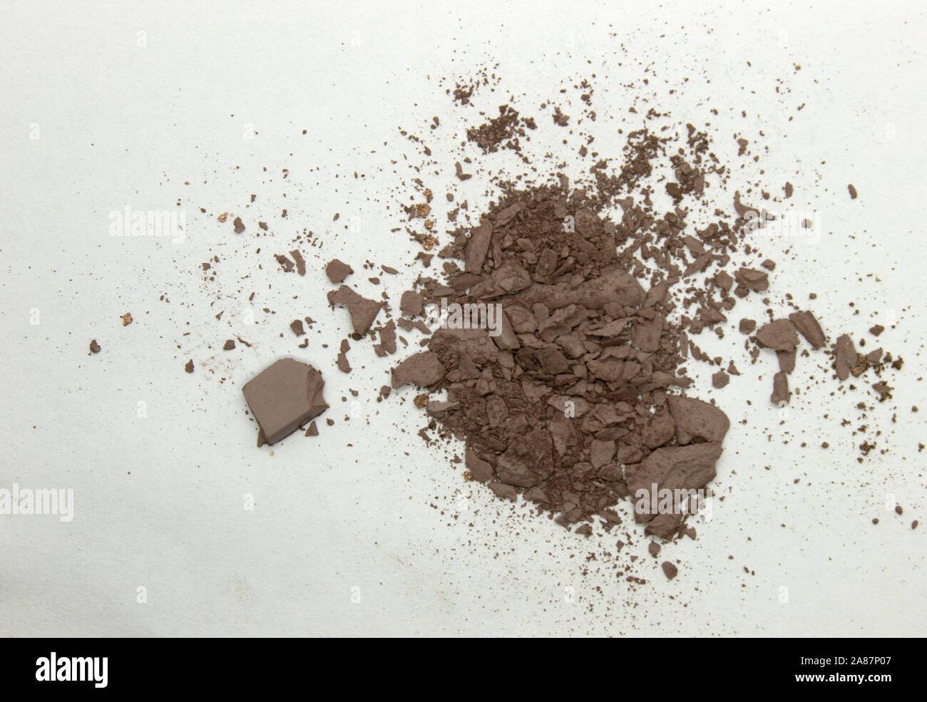 This is a photograph of a pale Brown matte powder Eye shadow isolated ...