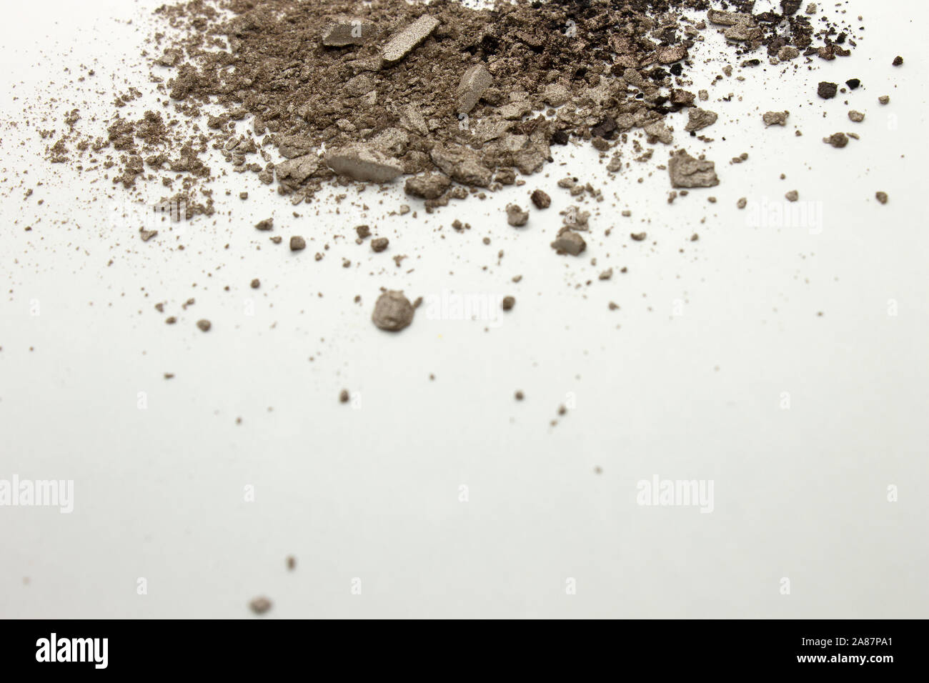 This is a photograph of a Greyish Brown powder Eye shadow isolated on a ...