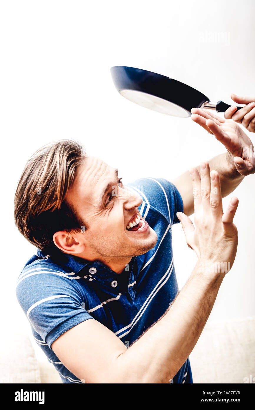 Woman hit man frying pan hi-res stock photography and images - Alamy
