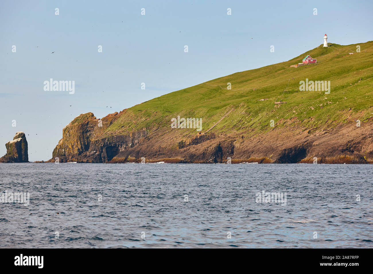 Mykines lighthouse and cliffs on Faroe islands. Hiking landmark ...