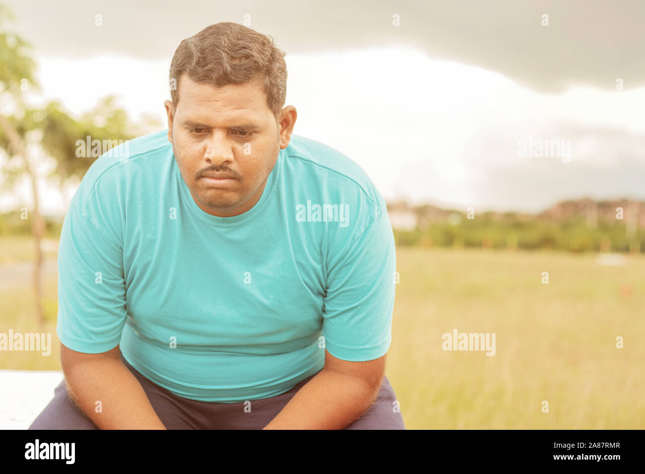 Fat man sitting park hi-res stock photography and images - Alamy