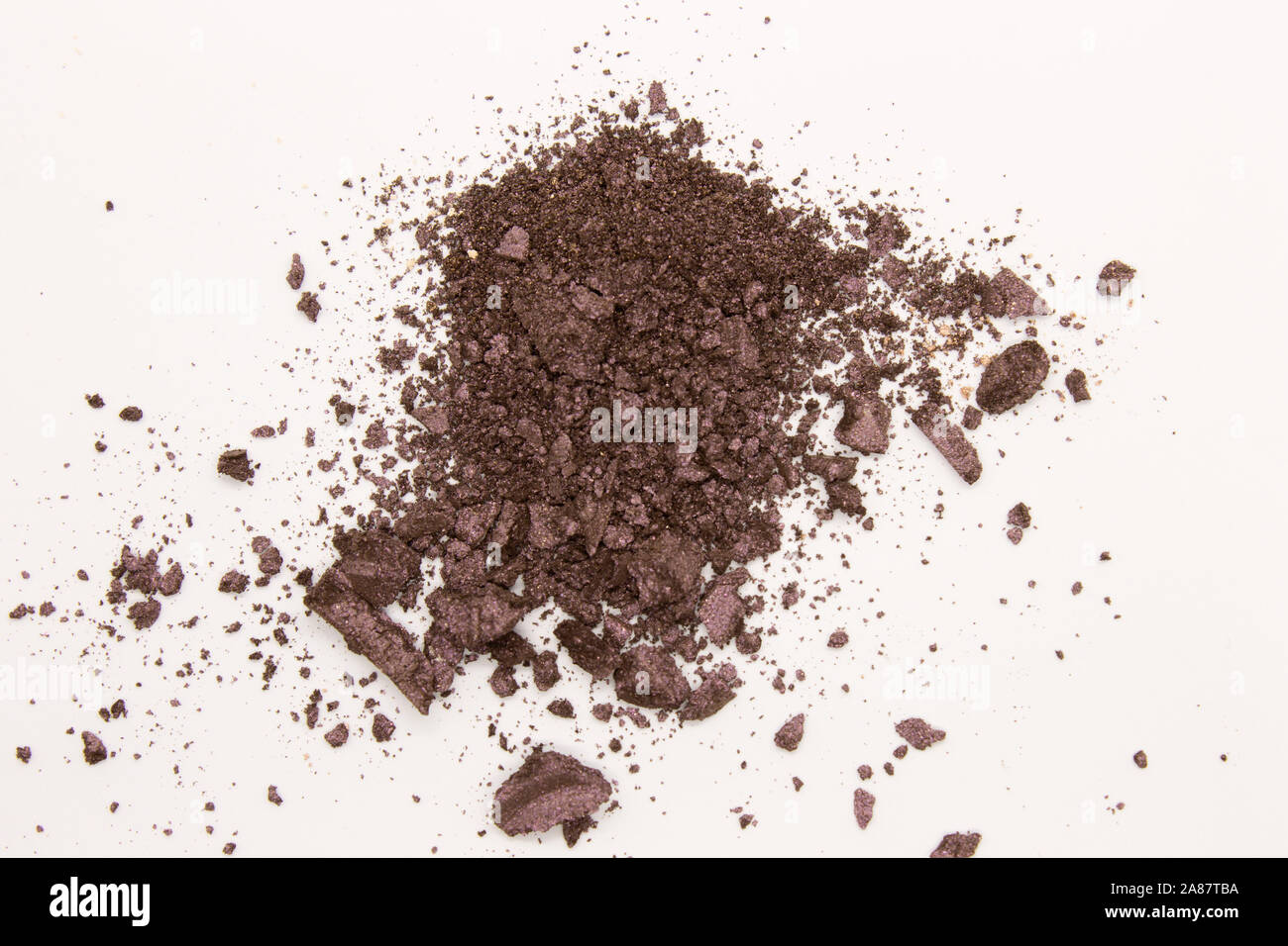 This is a photograph of a Dark Purple powder Eye shadow isolated on a ...